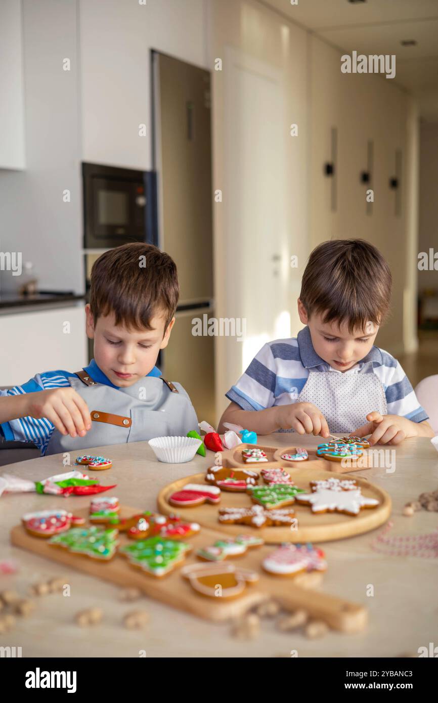 Happy family mother and children in aprons making Christmas cookies ...