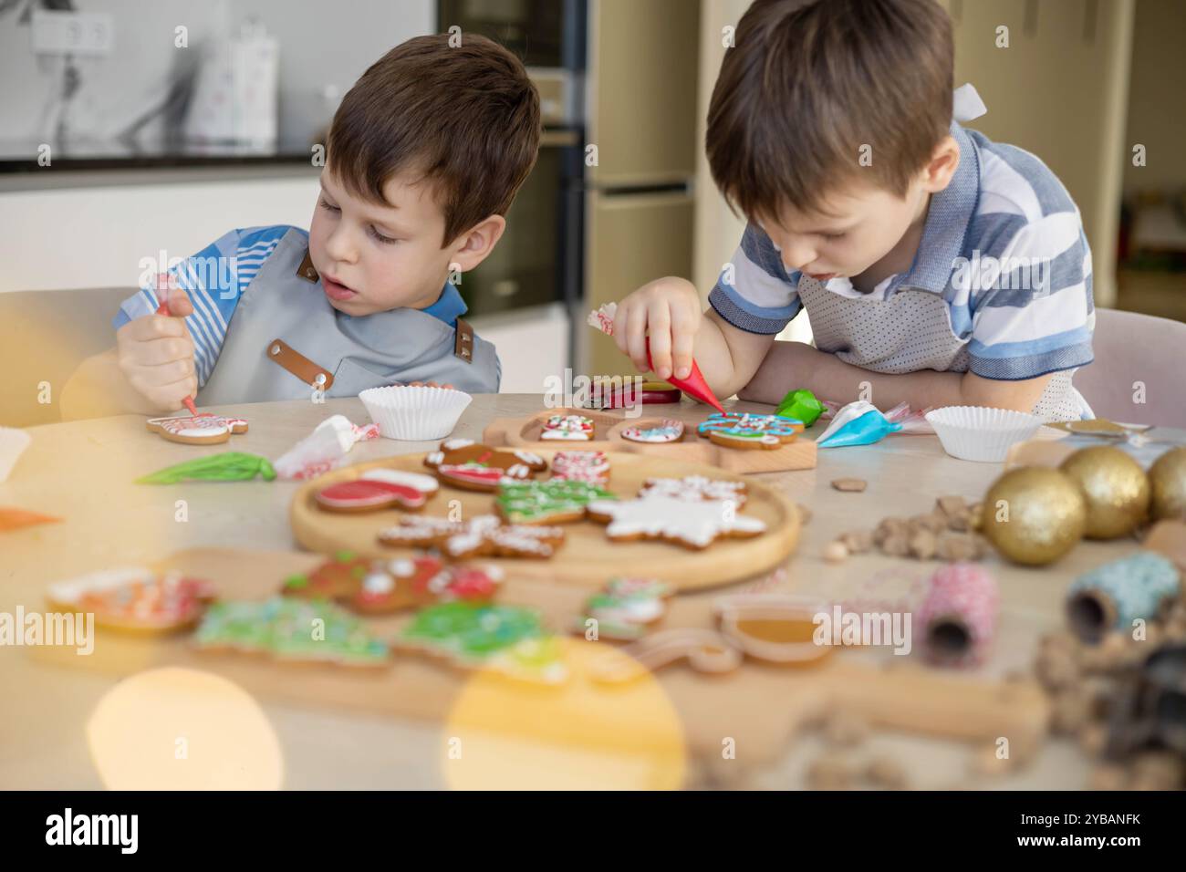 Happy family mother and children in aprons making Christmas cookies ...