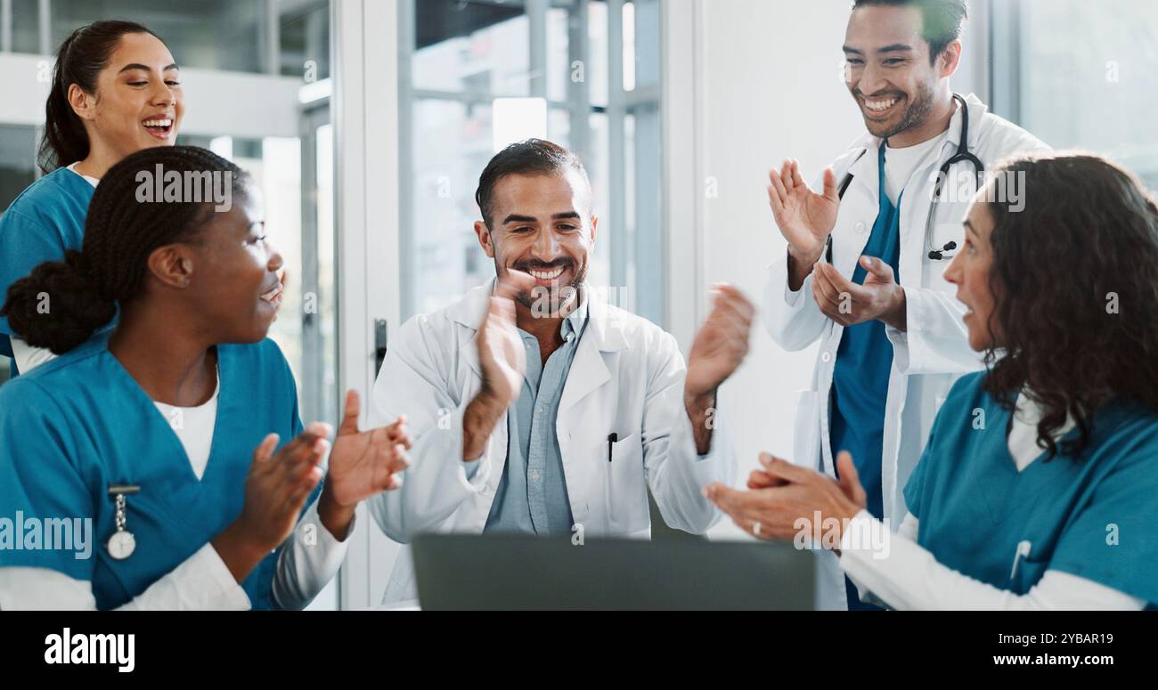 Group, doctor and laptop with applause in hospital for medical success ...
