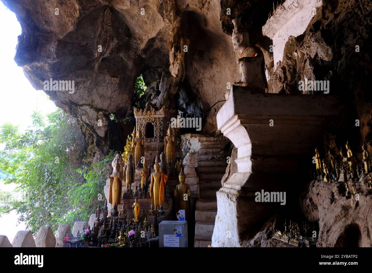 Tourists visiting the Lower Cave of Pak Ou Caves where aged Buddha ...