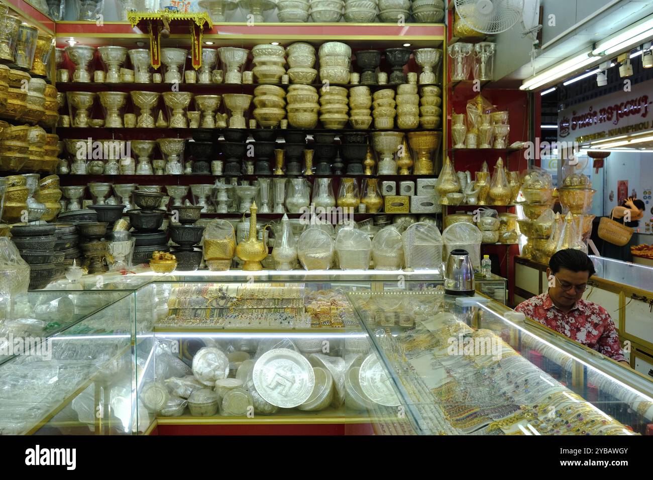A metal crafts and jewelry shop with a male shopkeeper inside of Talat ...