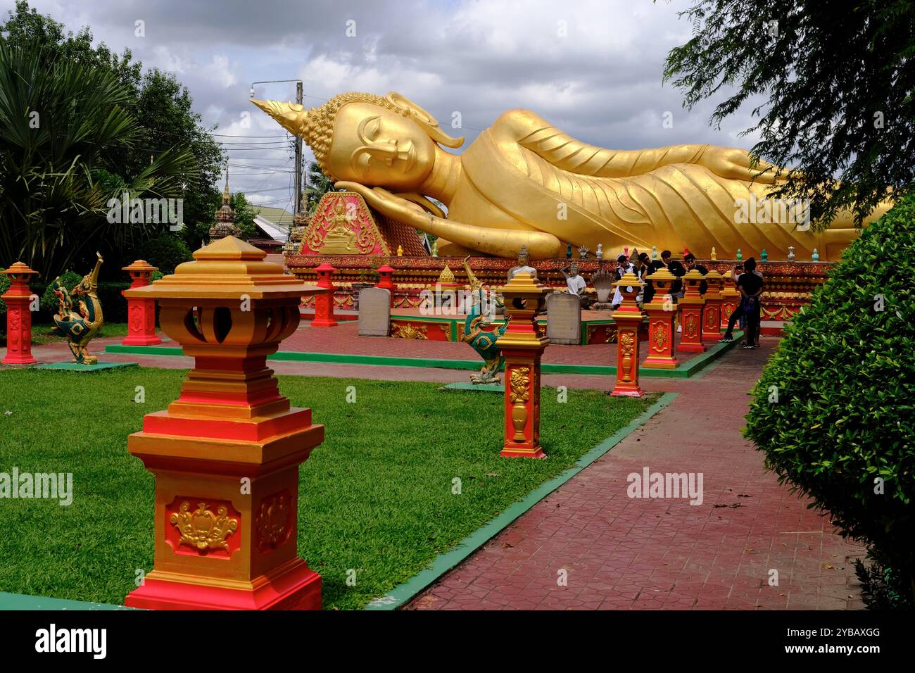 Giant Reclining golden Buddha in Wat That Luang Tai in Pha That Luang temple complex.Vientiane ...