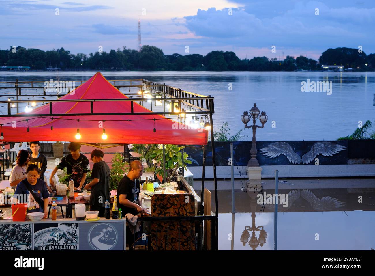 People working in the kitchen of a restaurant by the Mekong River in the Night Market. Vientiane ...