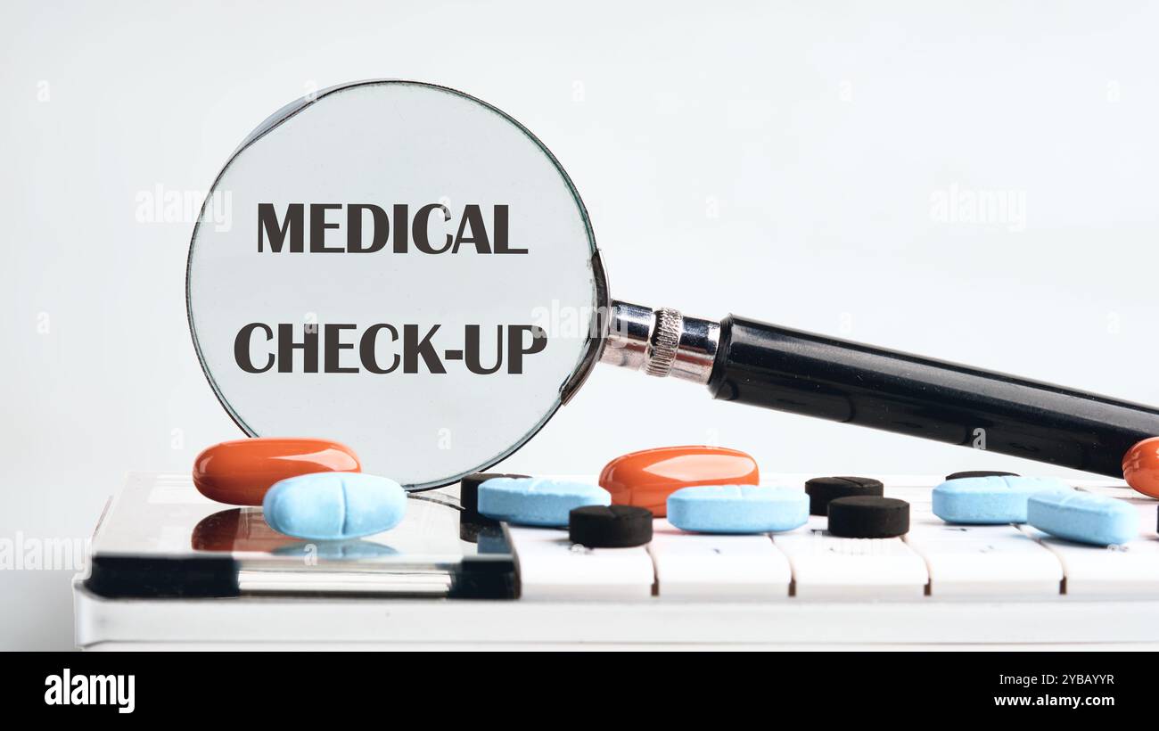 MEDICAL CHECK-UP words written through a magnifying glass on a light ...