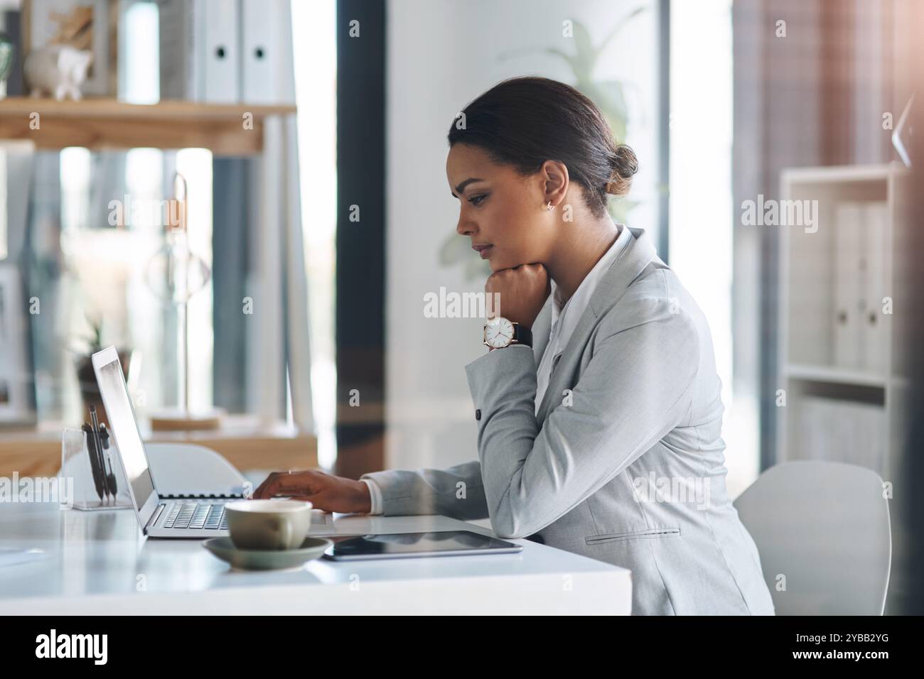 Office, businesswoman and reading with laptop for research, information and digital for report ...