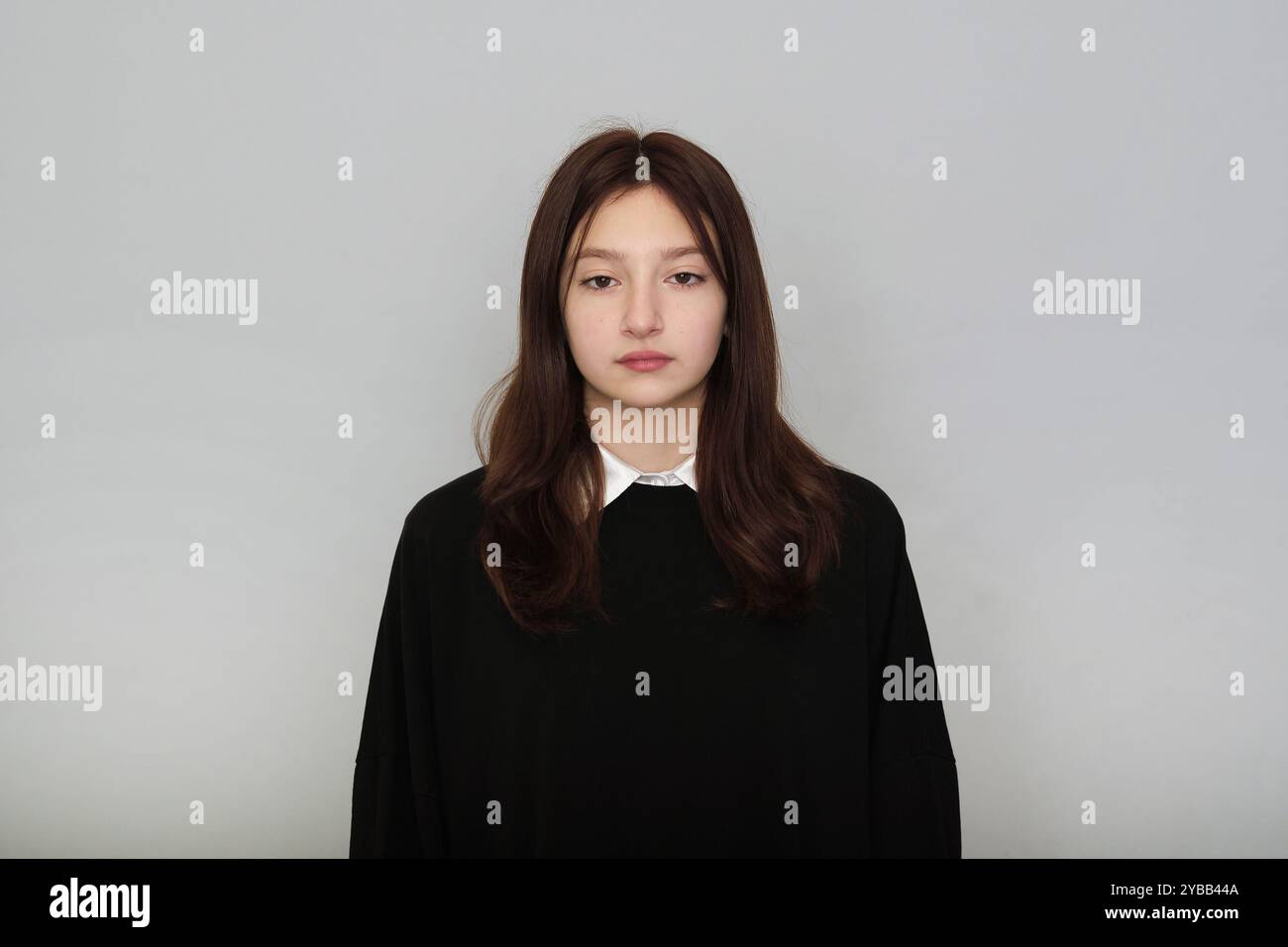Frontal view of a somber female in a plain black hoodie, perfect for ...