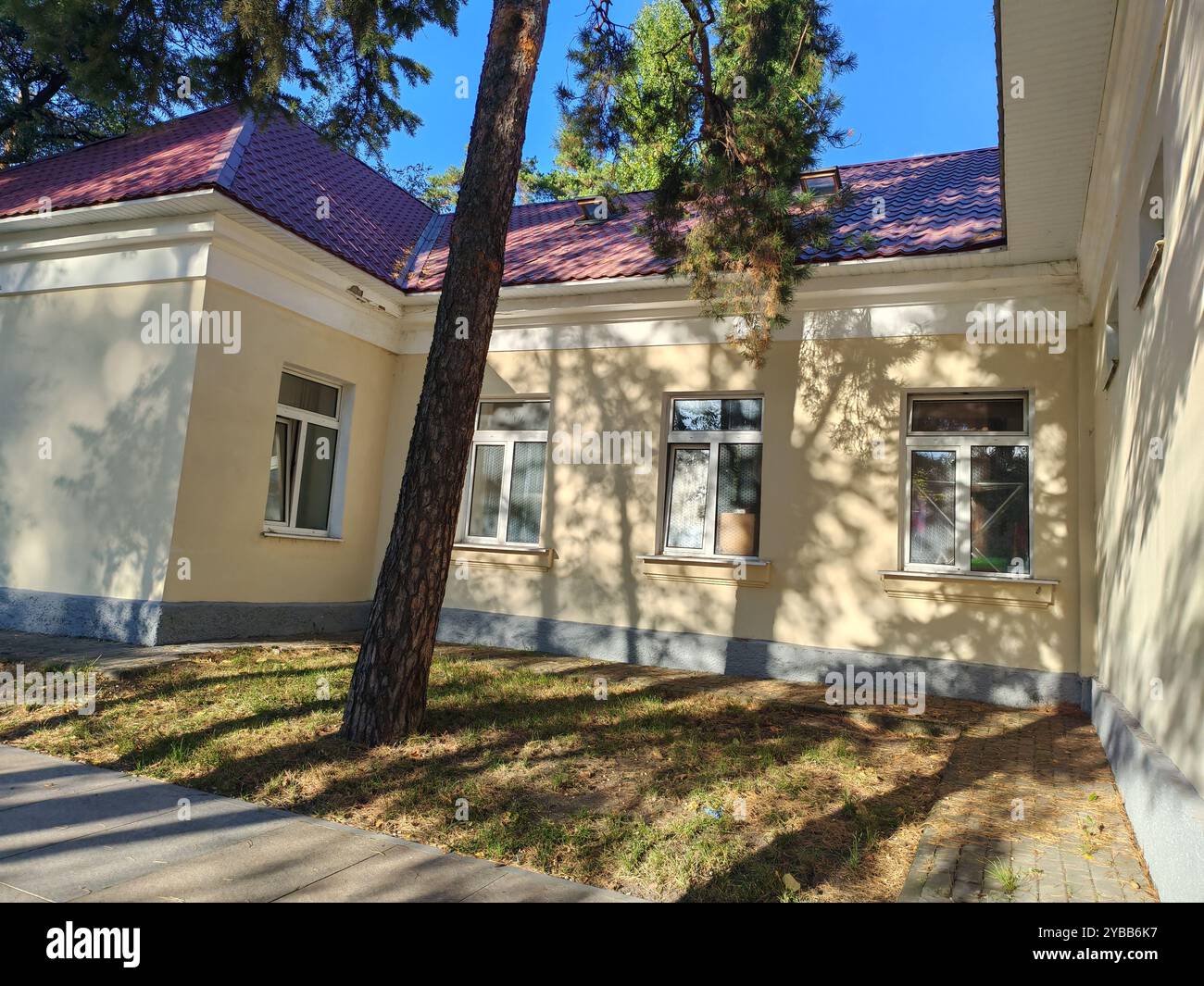 historic building with red brick columns and a sloping roof, nestled ...