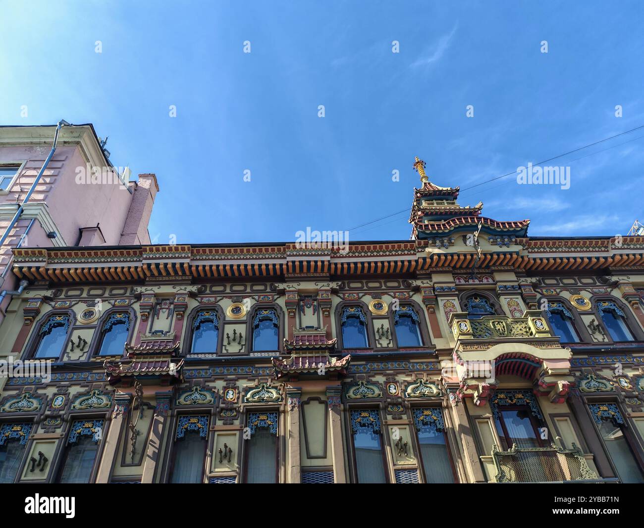 grand yellow building with symmetrical windows and classical detailing ...