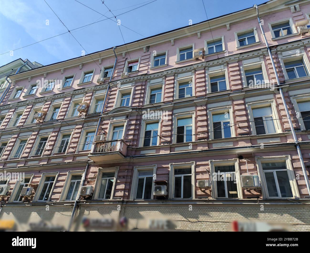 multi-story pink building with ornate details and air conditioning ...