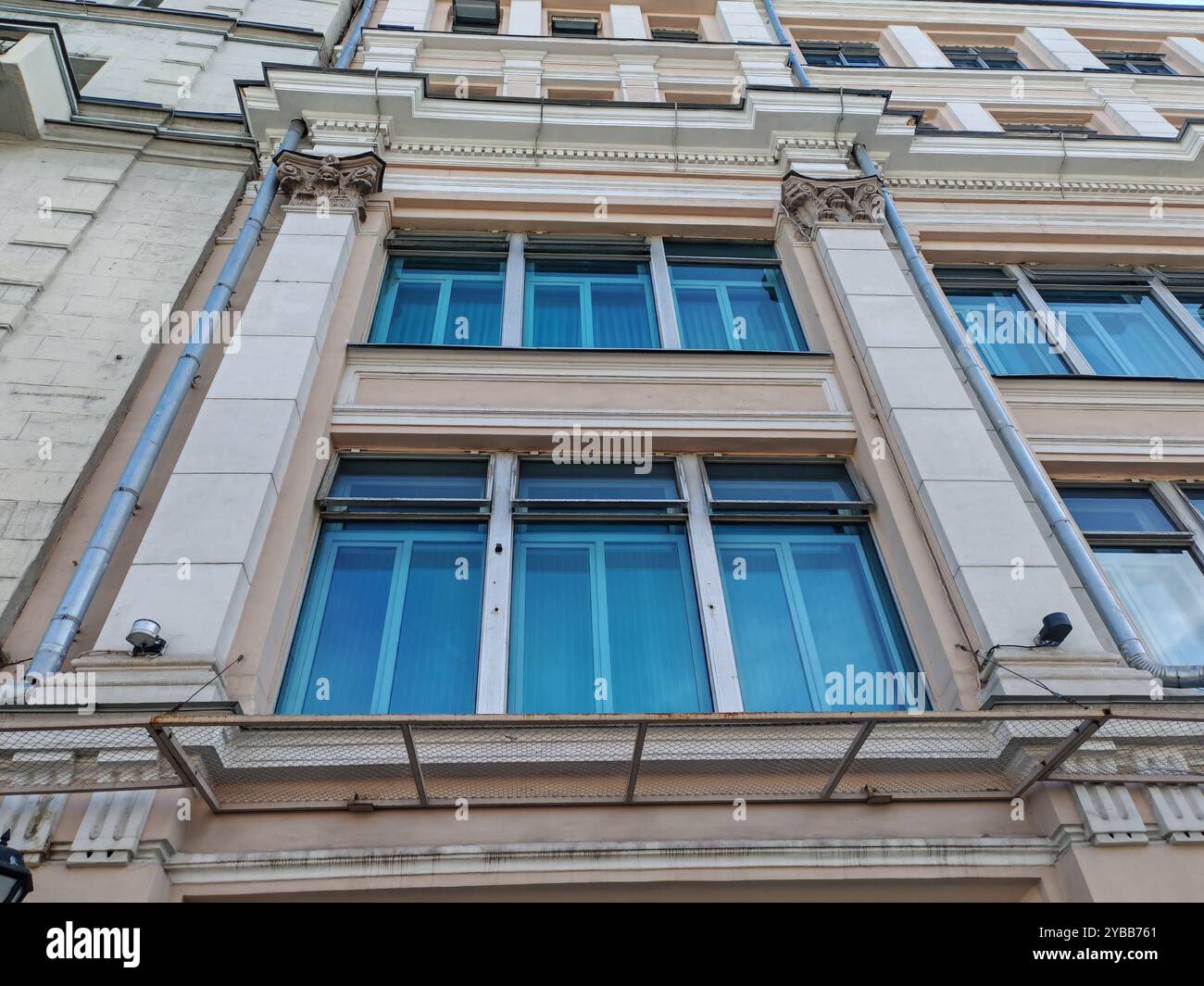 large yellow building with multiple windows and an arched doorway ...