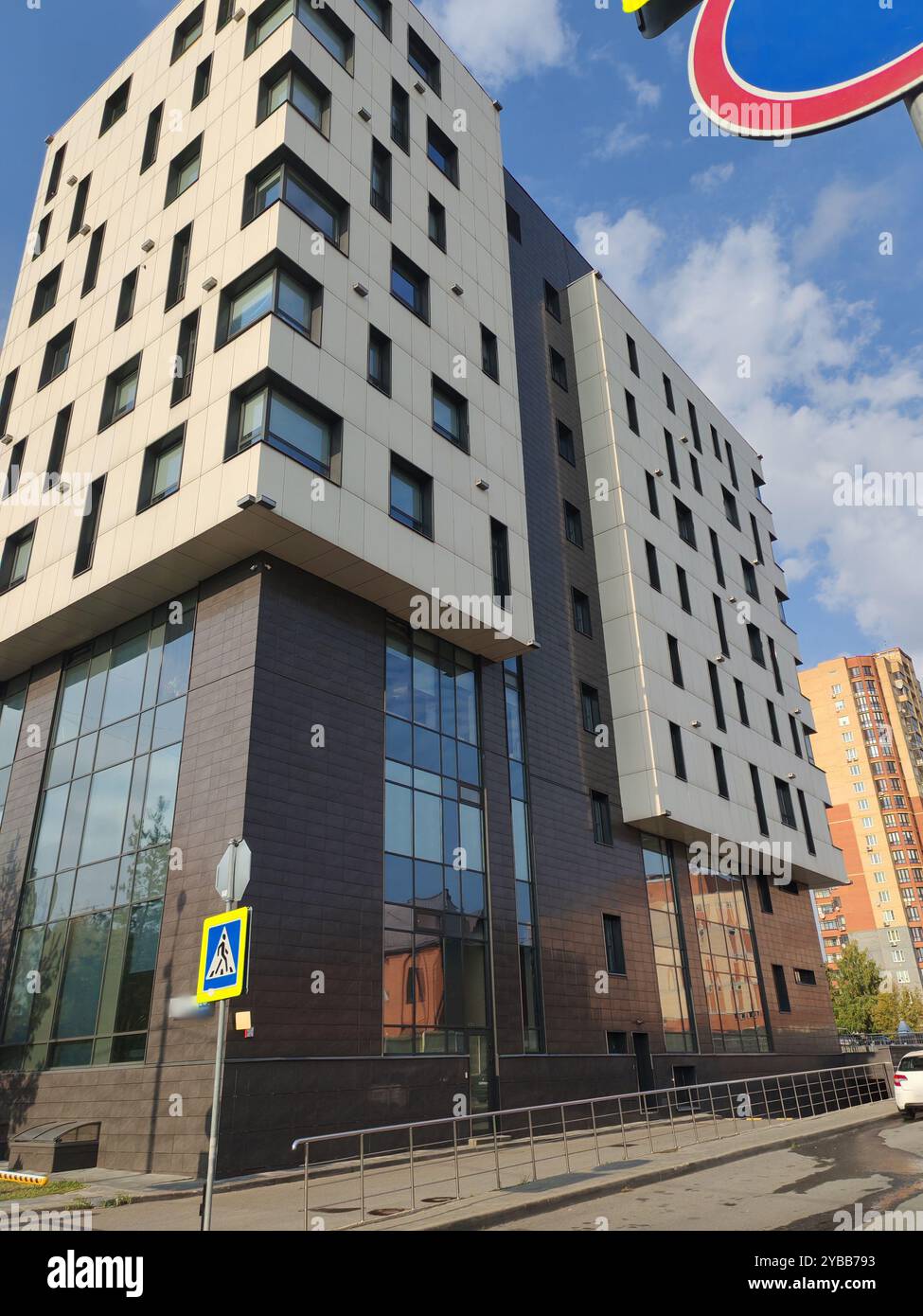 Modern Urban Building With Large Glass Sections And Angular Panels Featuring Minimalist Design