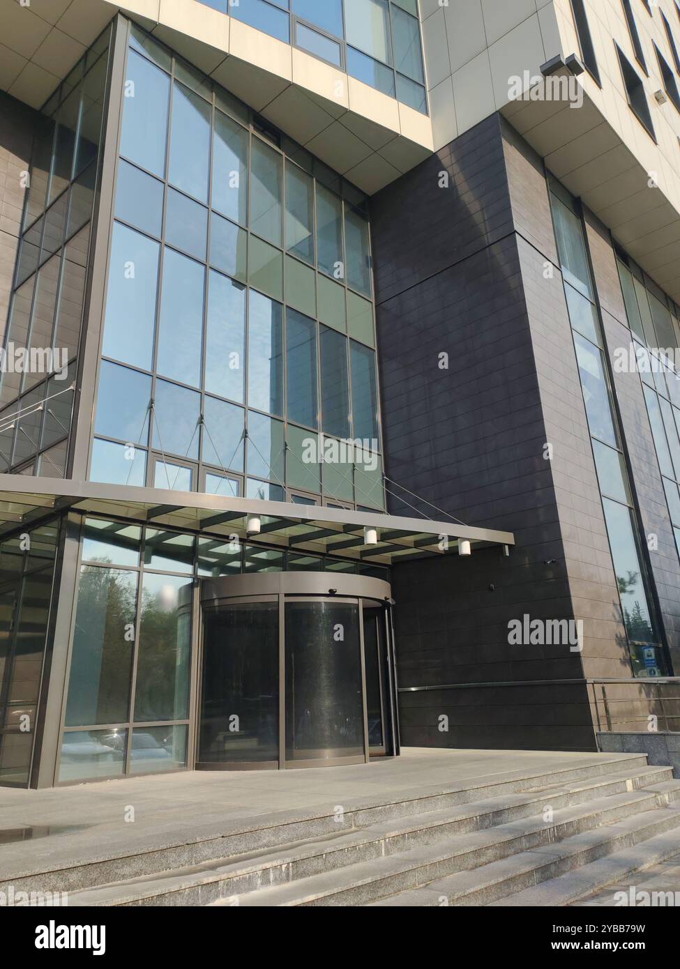 Modern Urban Building With Large Glass Sections And Angular Panels Featuring Minimalist Design