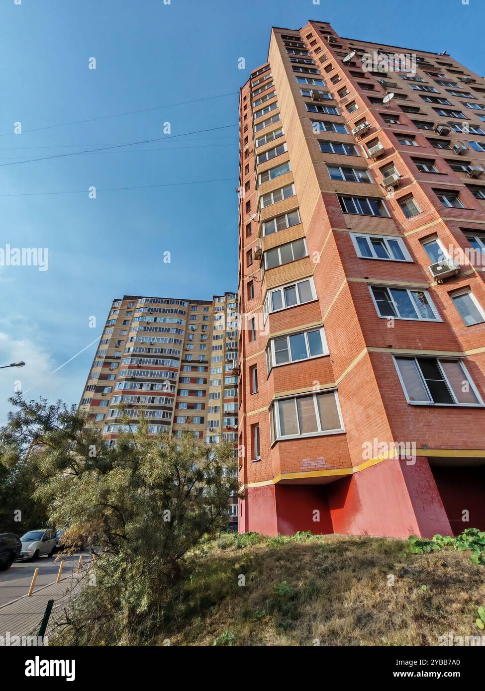 A high-rise residential building featuring a mix of red and beige brick ...
