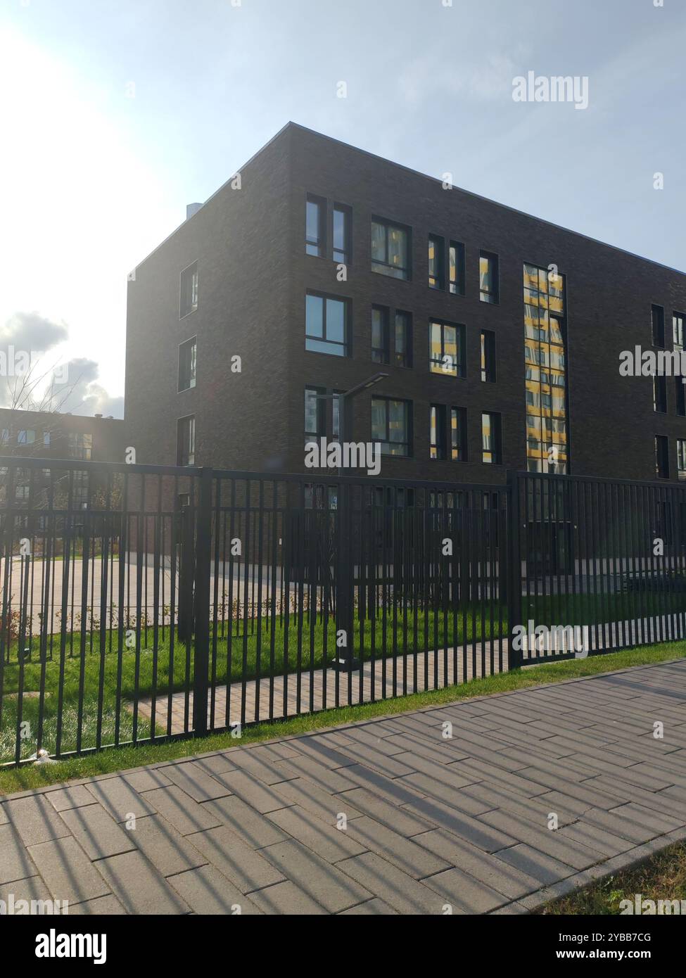 pair of tall apartment buildings with bold color schemes—one in yellow ...