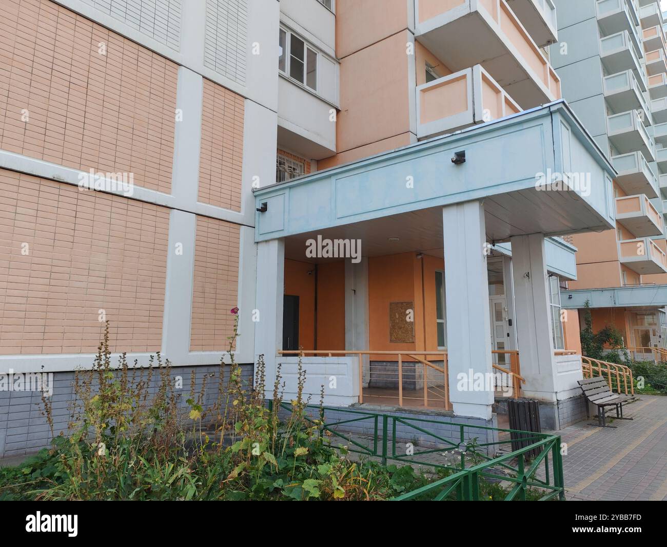 A large multi-story residential building with a pastel color palette of ...