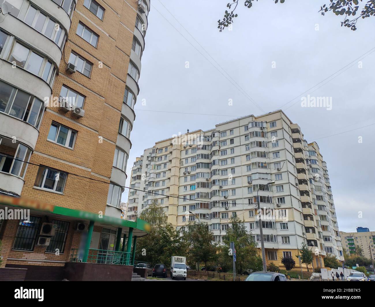 A pastel-colored high-rise residential building with curved balconies ...