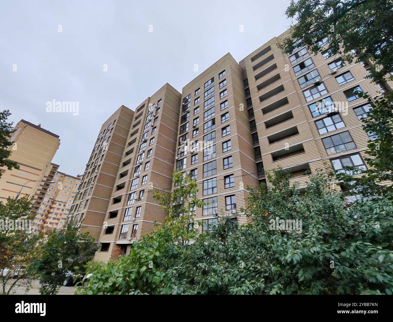 high-rise apartment building with light pastel colors and numerous ...