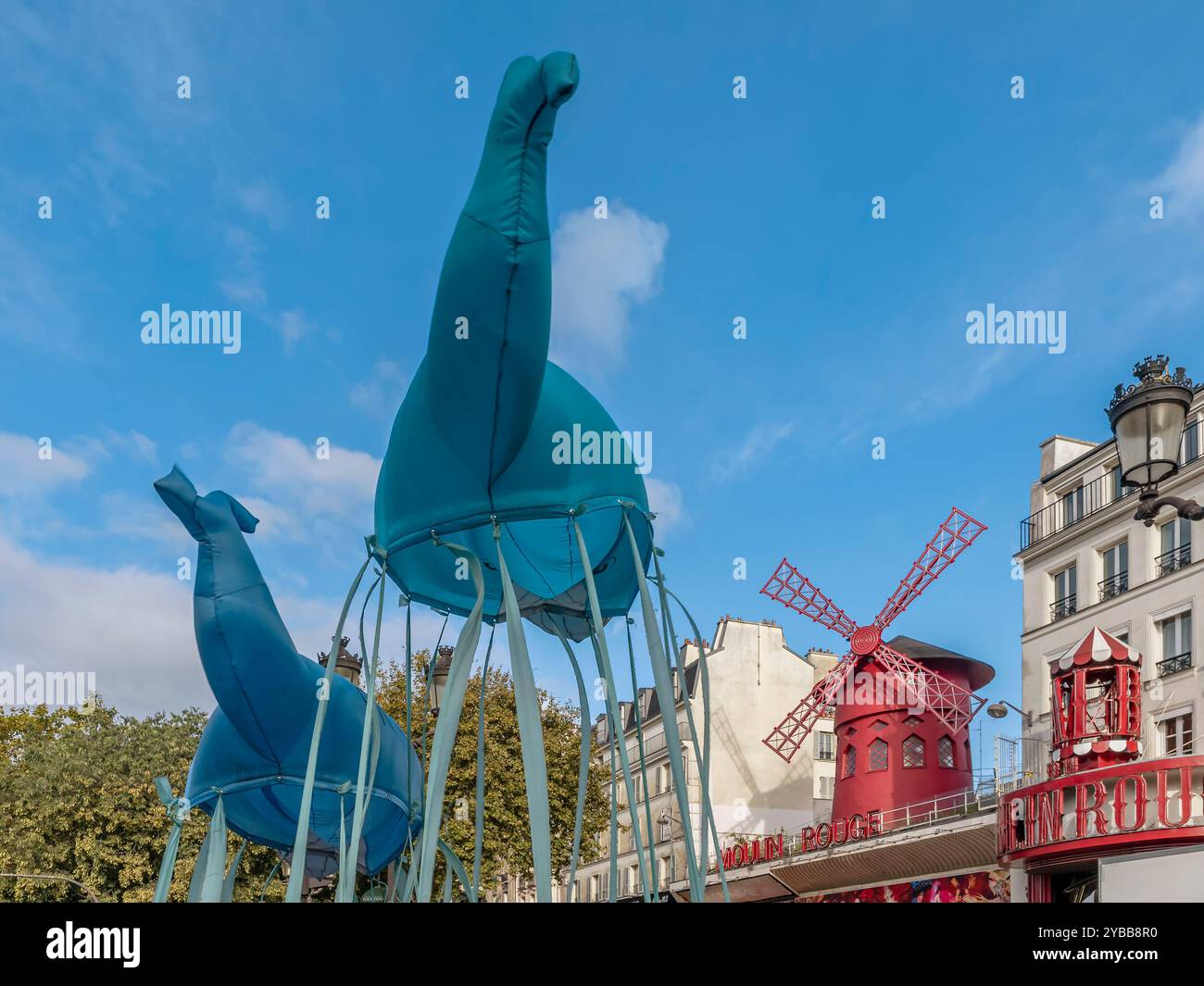 Inflatable blue whales float in the air for a demonstration in front of ...