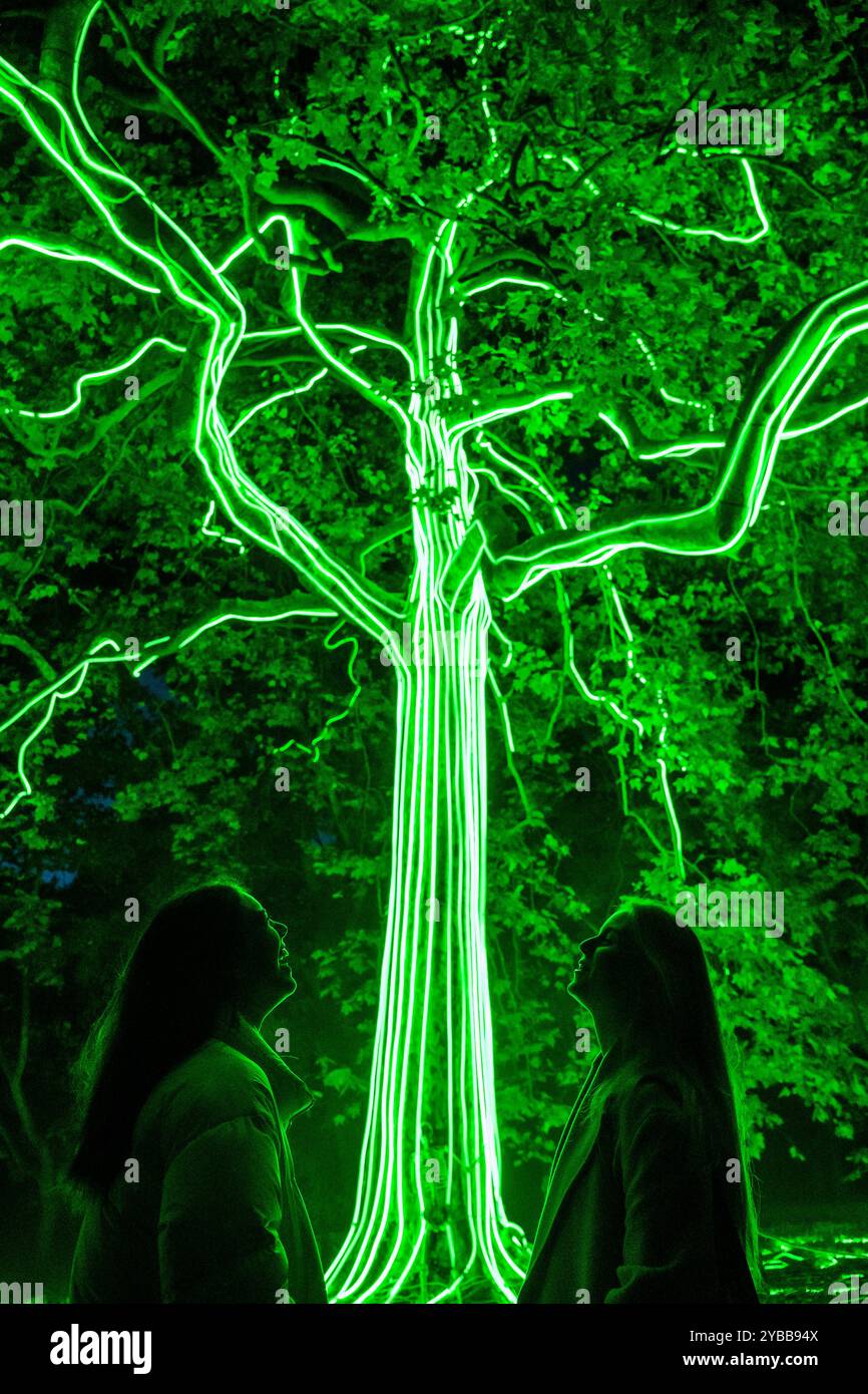 London, UK. 17th Oct, 2024. Visitor enjoy a neon Carnivorous Tree ...