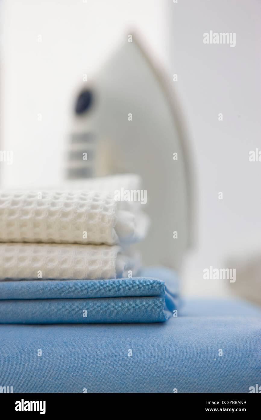 Close up of a stack of bed linen and an iron Stock Photo - Alamy