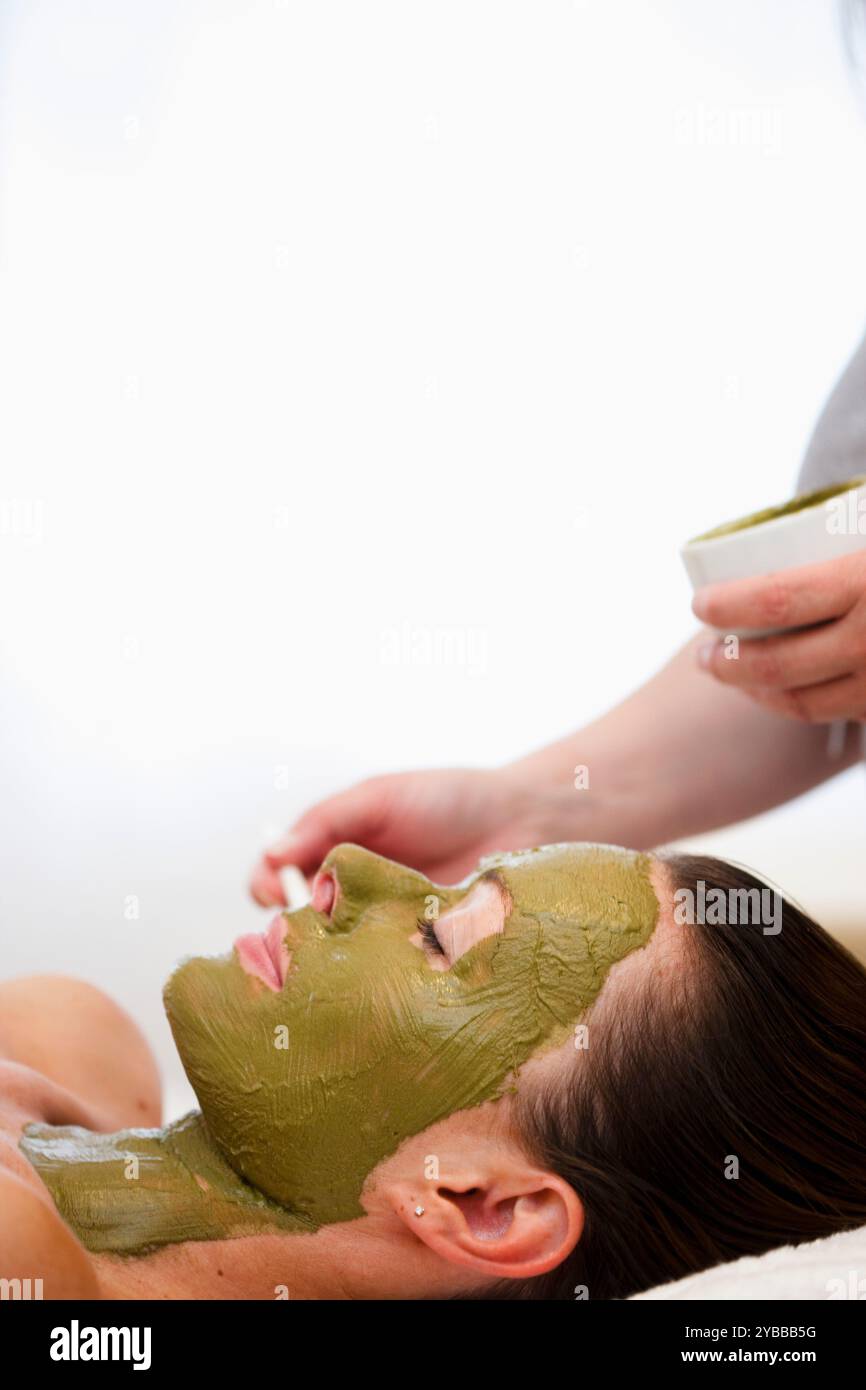 Beautician applying green mask on hi-res stock photography and images ...