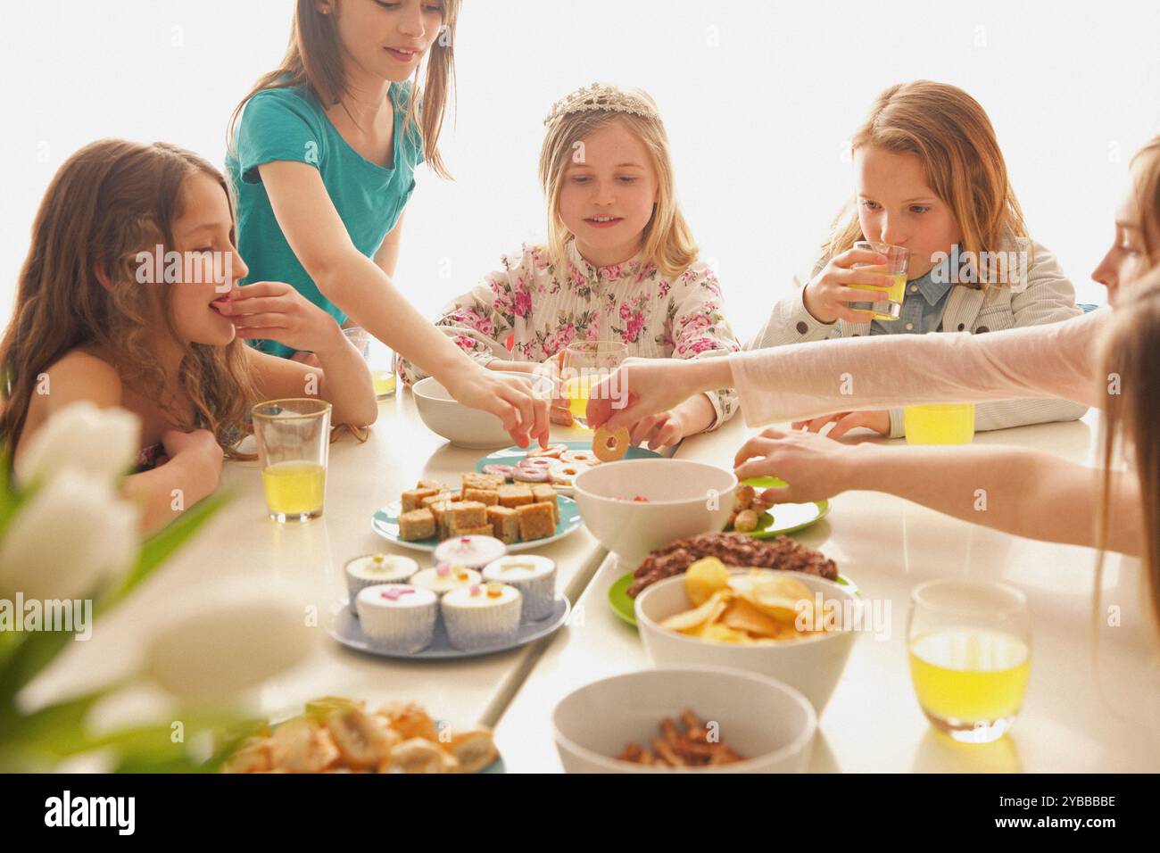 Group of Girls Eating and Drinking Around Table Stock Photo - Alamy