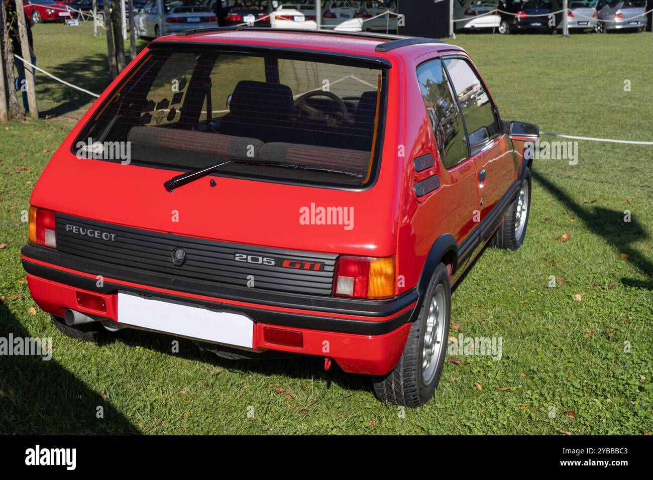 Red peugeot 205 gti is parked on a grass field at a car show Stock Photo - Alamy