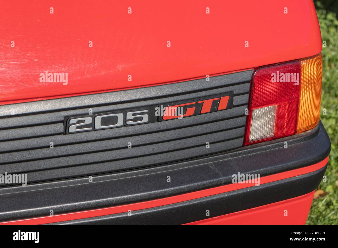 Closeup of the peugeot 205 gti rear badge showing branding and model ...