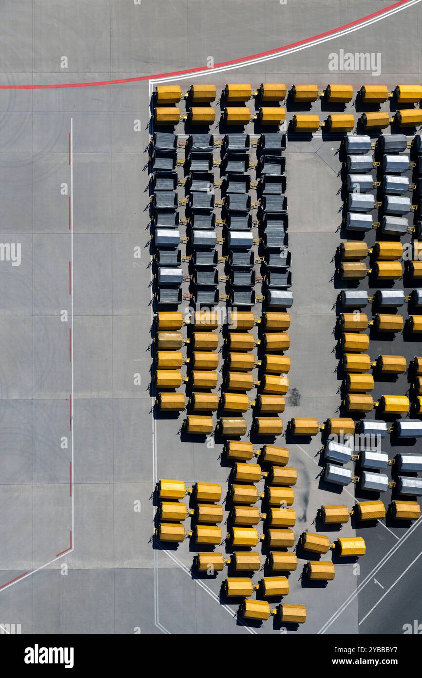 View from above empty yellow and black luggage carts on sunny airport ...