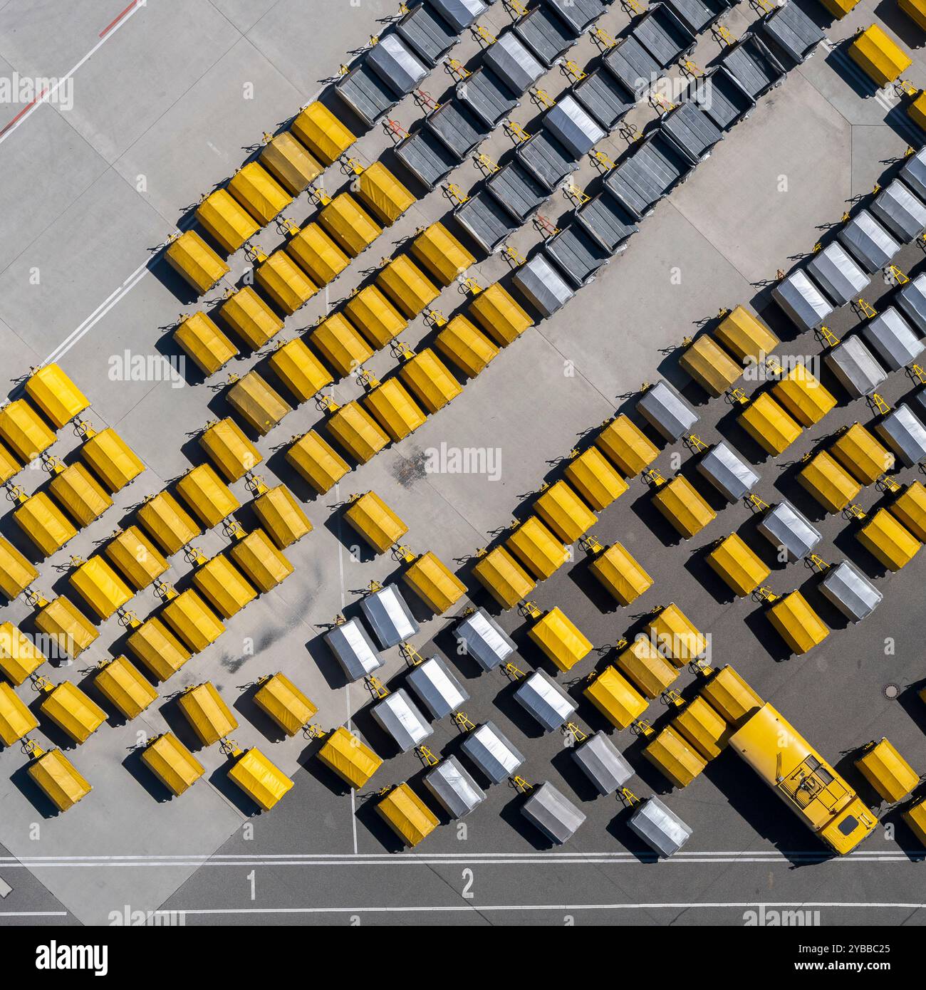 View from above empty yellow and black luggage carts on sunny airport ...
