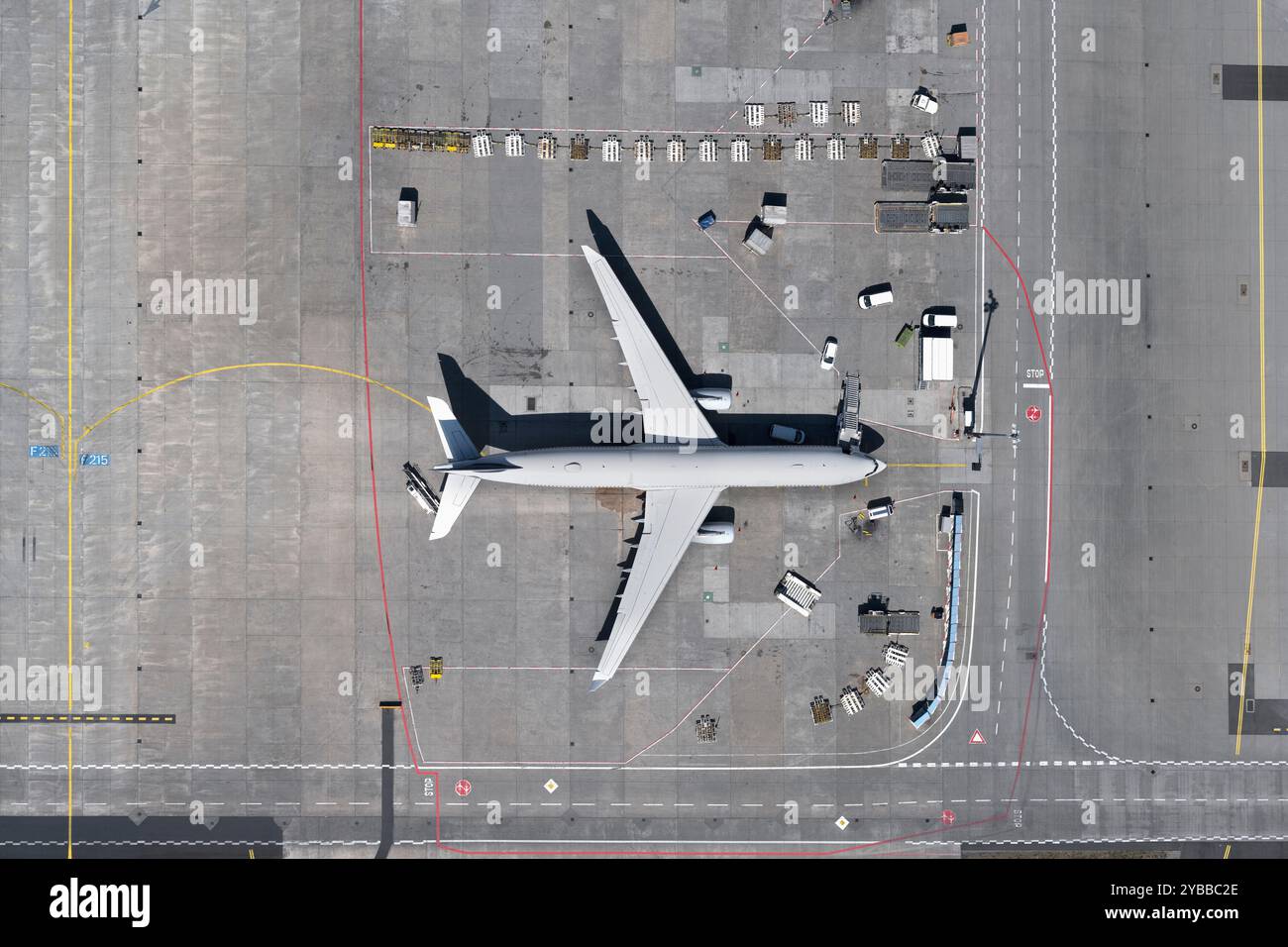 View from above airplane and service vehicles on sunny airport tarmac ...