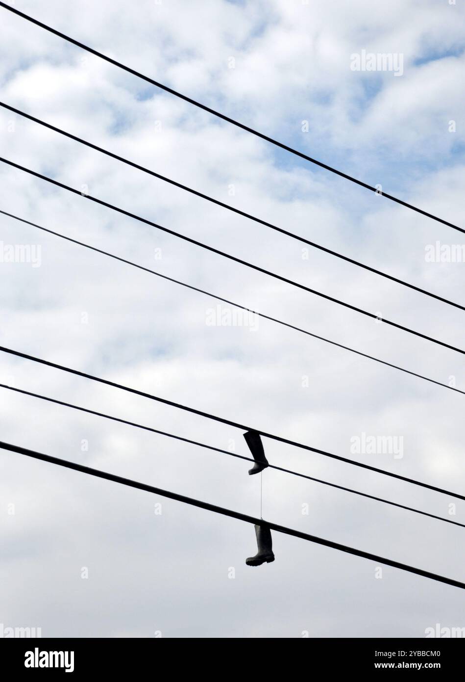 Photography of rubber boots hanging on power lines Stock Photo - Alamy