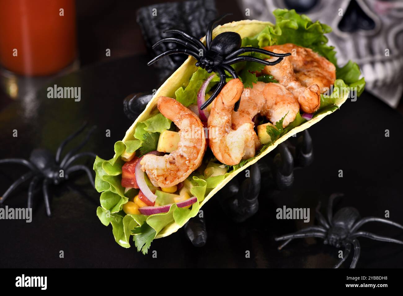 Black monster hand holding tacos crispy fried shrimp. Halloween party ...