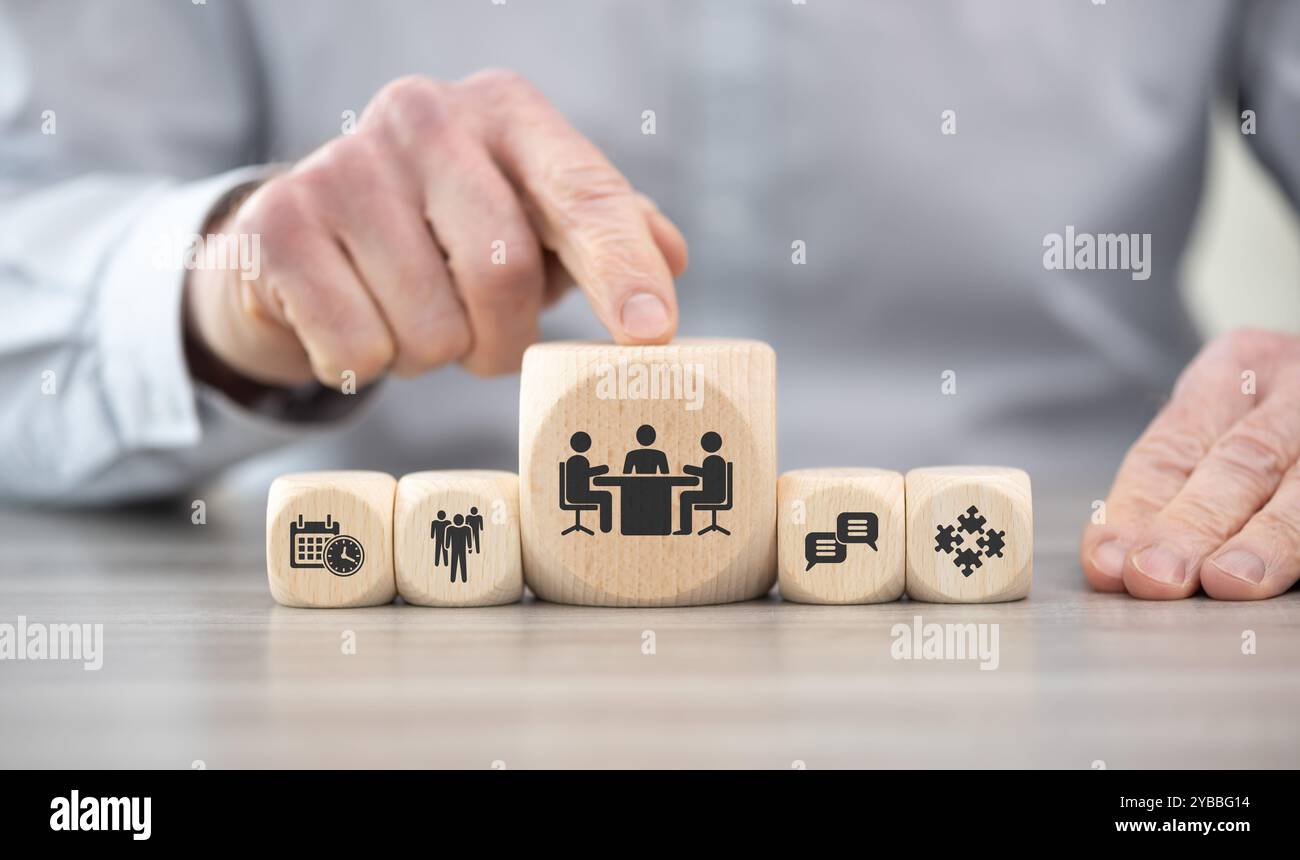 Wooden blocks with symbol of meeting concept Stock Photo - Alamy