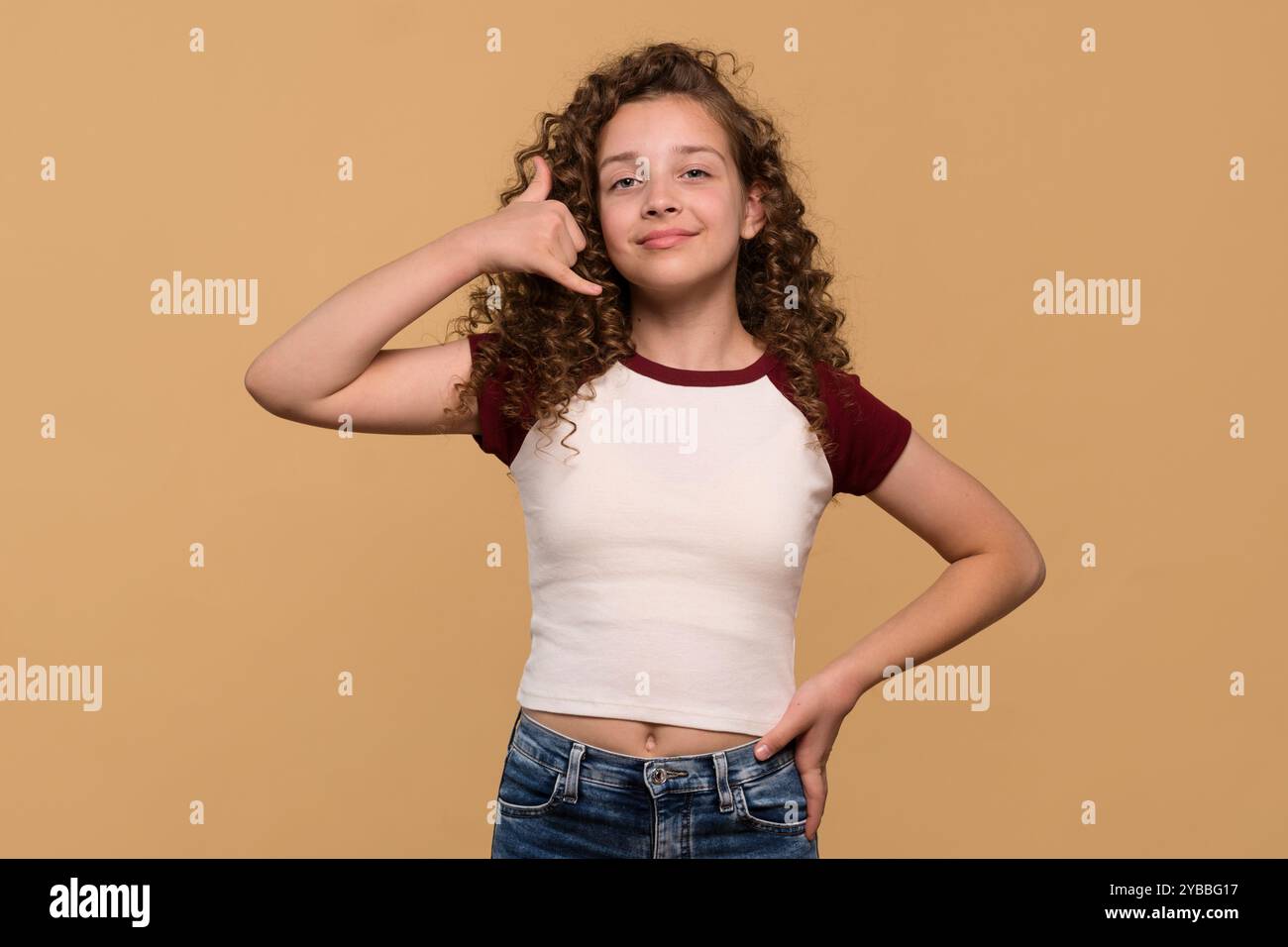 Girl posing with hand gesture, expressing a call me sign Stock Photo ...