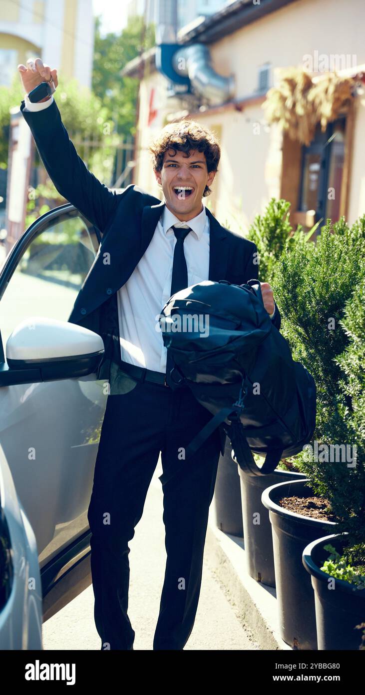 Happy and excited man, employee standing beside his new car. Getting ...