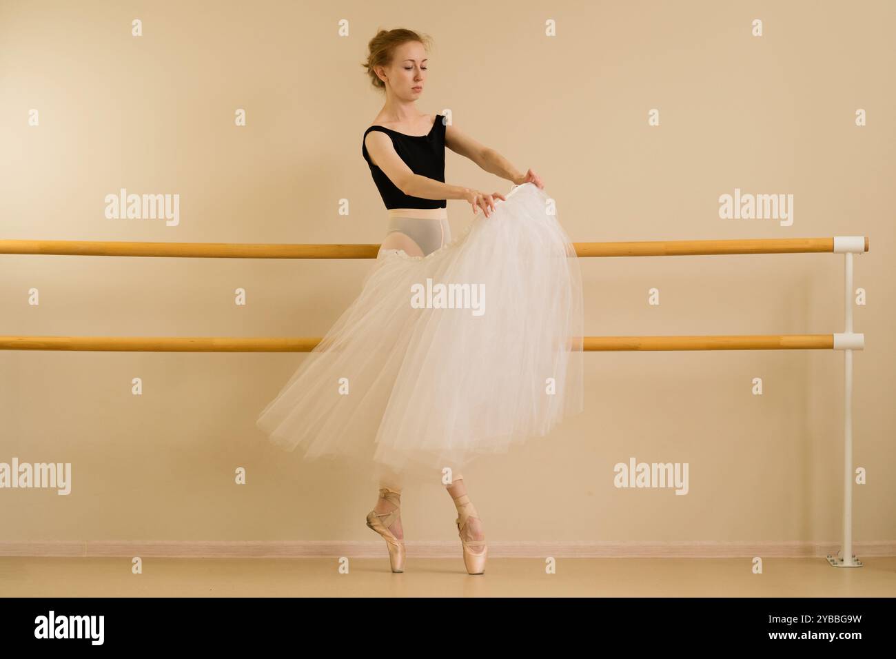 A ballet dancer showcases a dynamic pose in a serene studio setting ...