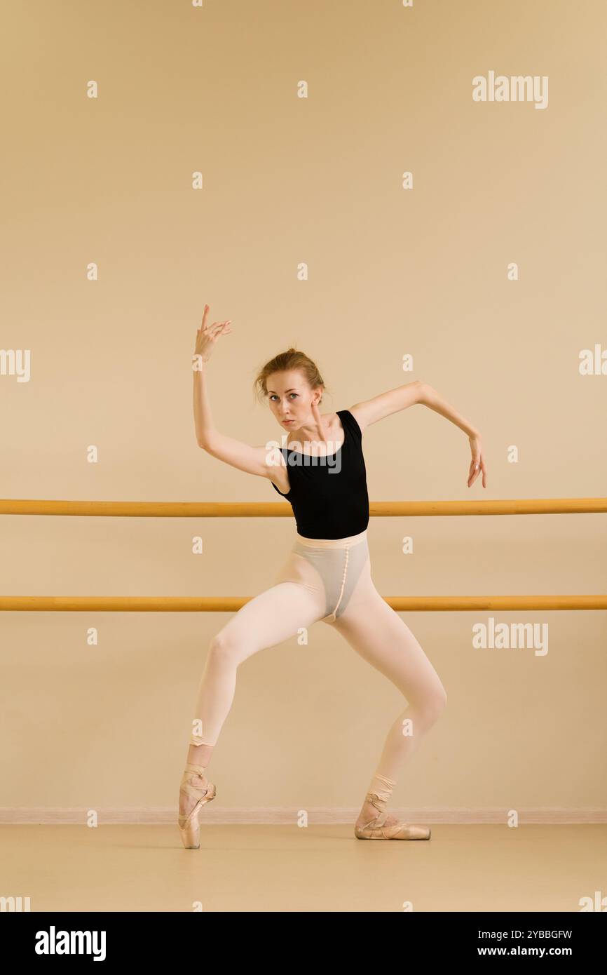 Ballet dancer striking dynamic pose with expressive arm gesture in ...