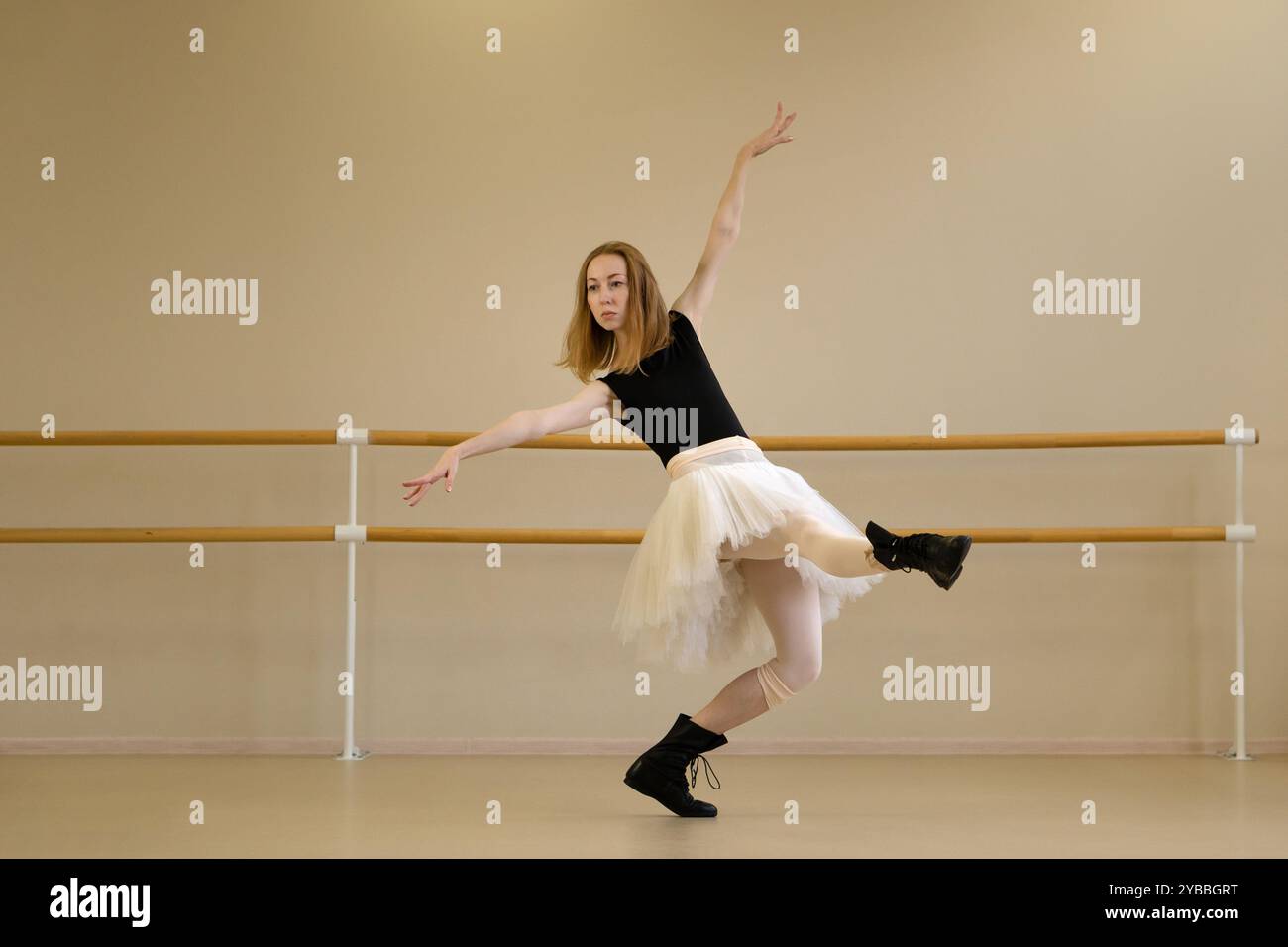 Ballerina in shoes and tutu, extending arm while performing a modern ...