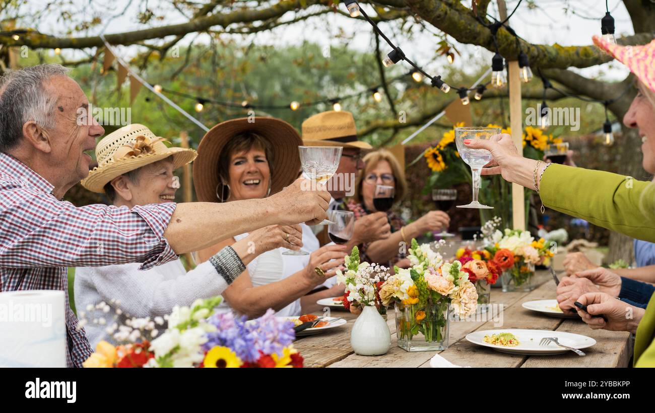 Intimate view of senior hands toasting with wine glasses during an ...