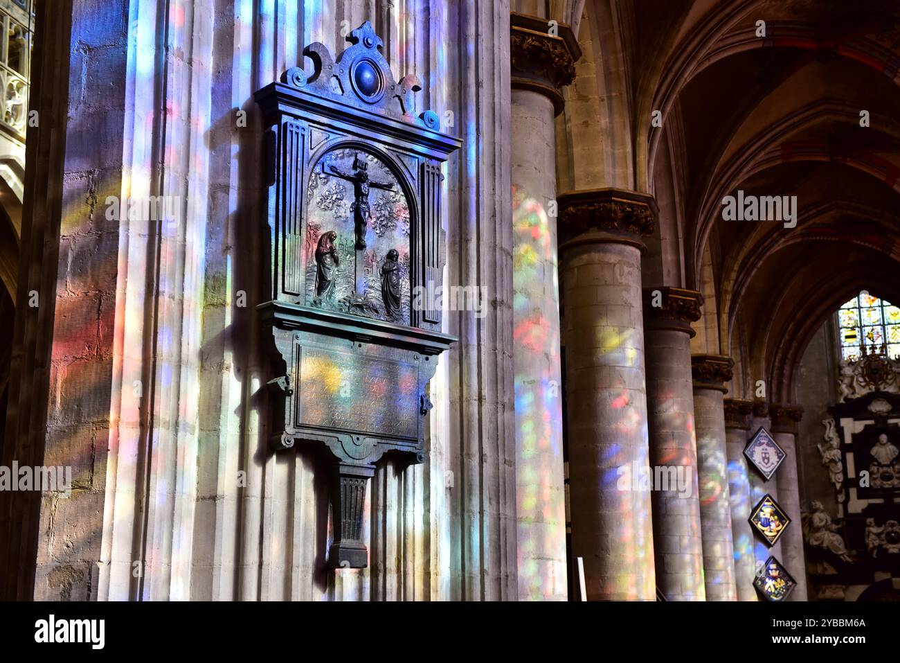 Oblique sunlight shone through stained glass windows onto pillars in ...