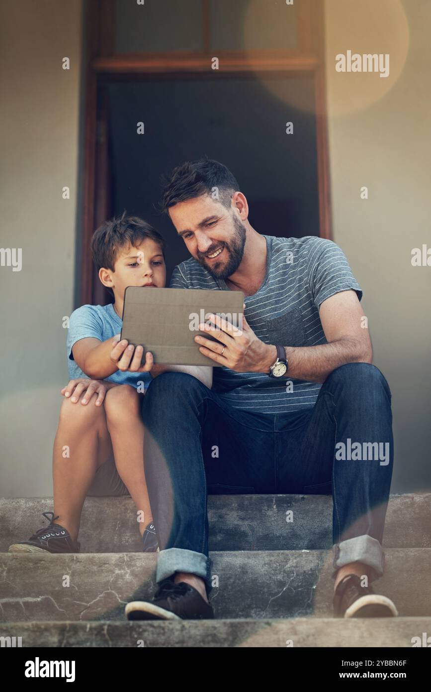 Home, father and child with tablet on steps for watching cartoon ...