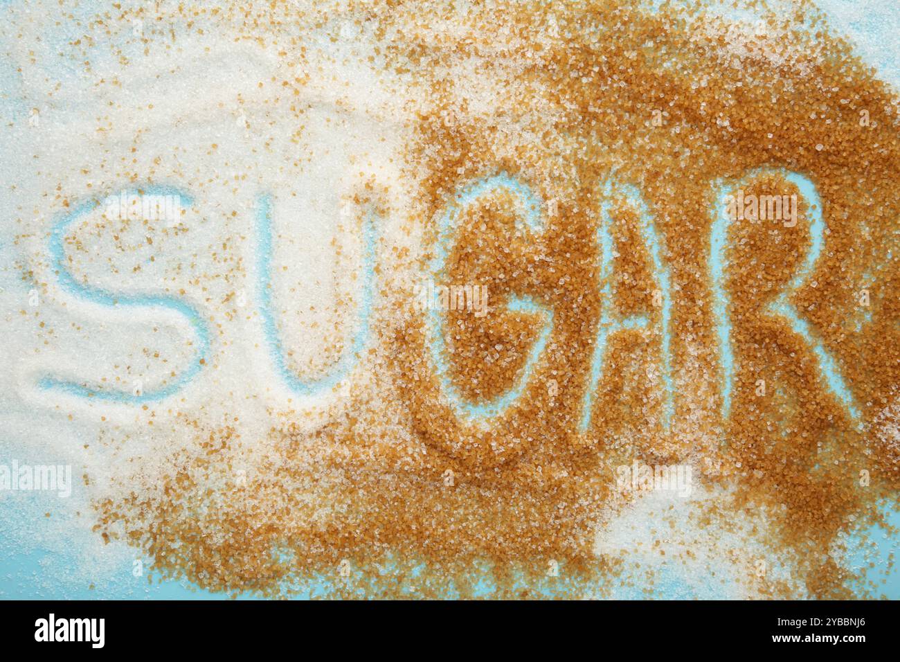 The word sugar written into a pile of white granulated sugar with blue ...