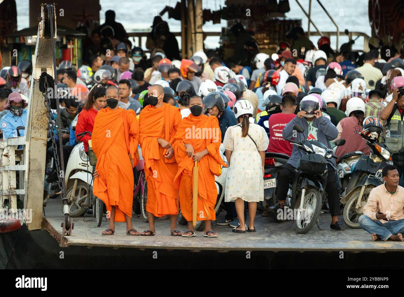 People crossing Tonle Sap river on a ferry at Kampong Chamlong Phnom ...