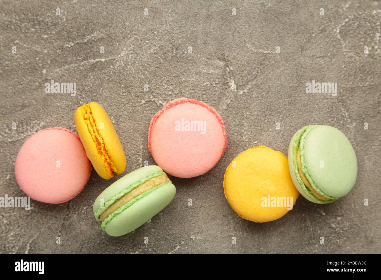 Colorful macarons cakes on grey background. Small French cakes. Top ...