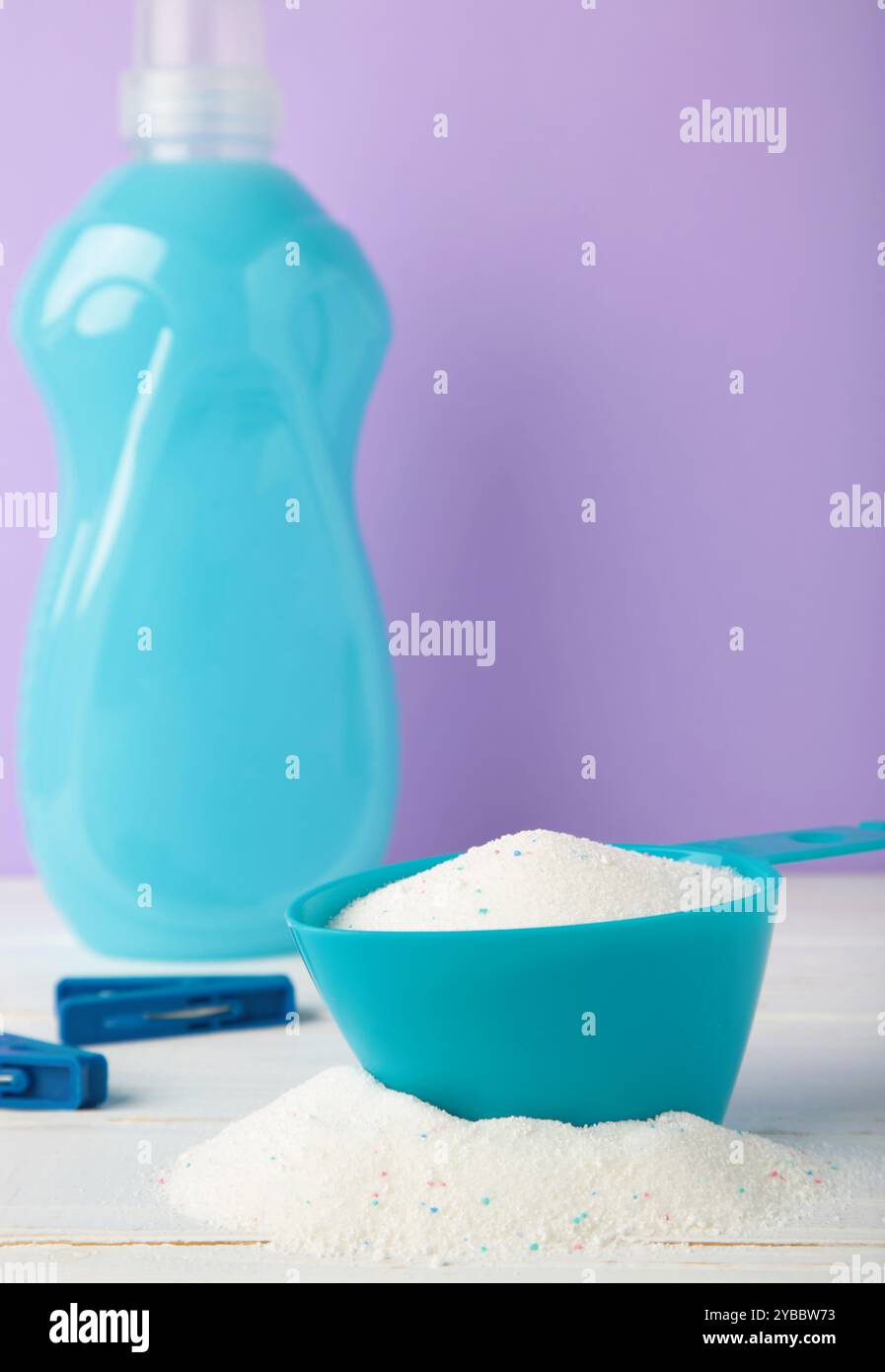 Laundry detergents with washing powder on purple background. Vertical ...