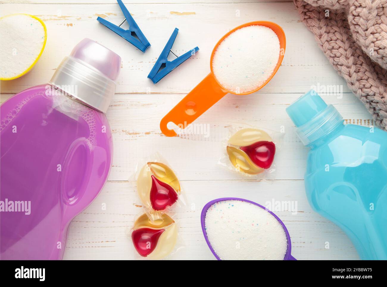 Laundry detergents with washing powder and capsules on white background ...
