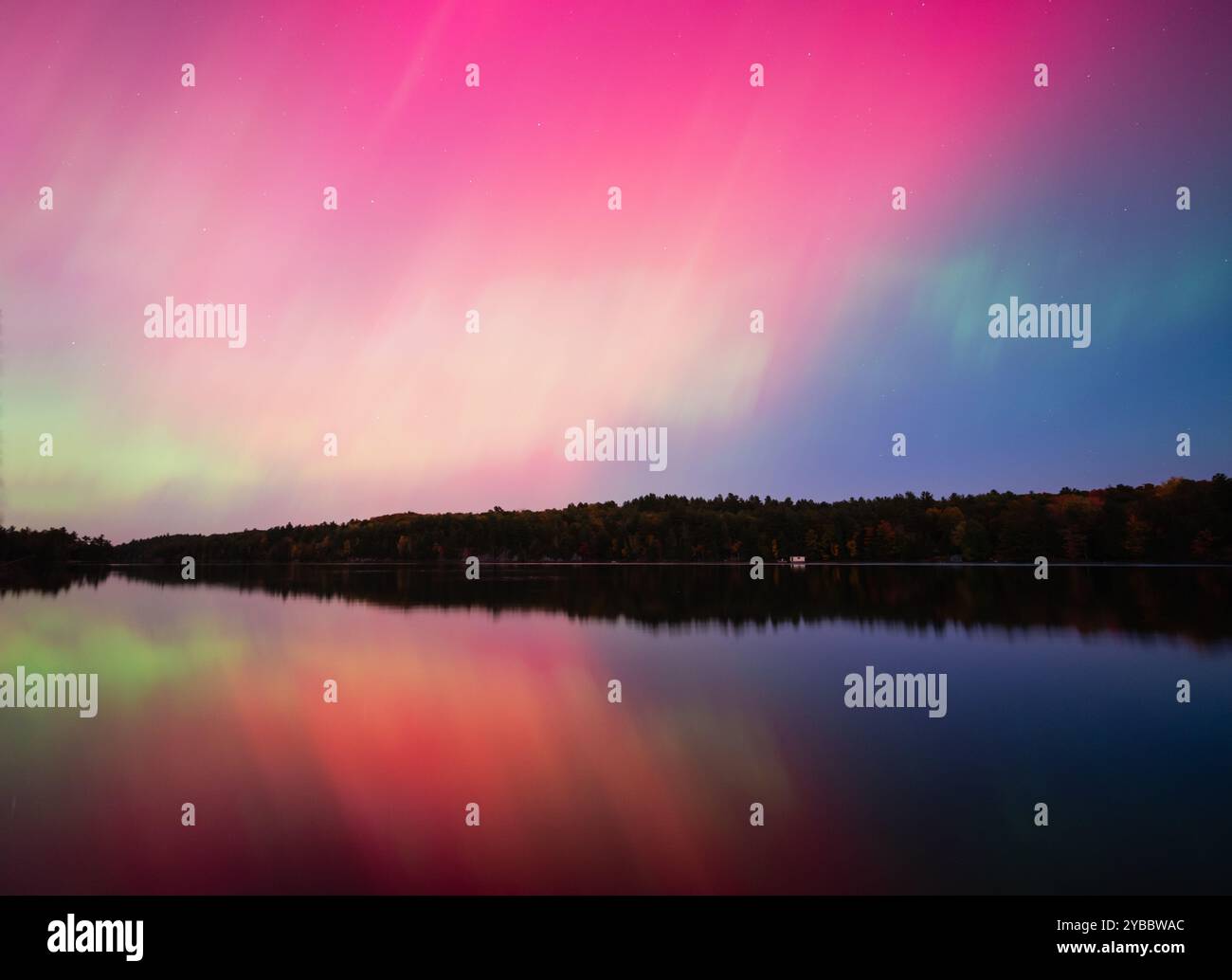 Colorful Aurora Borealis northern lights in sky over lake in Canada ...