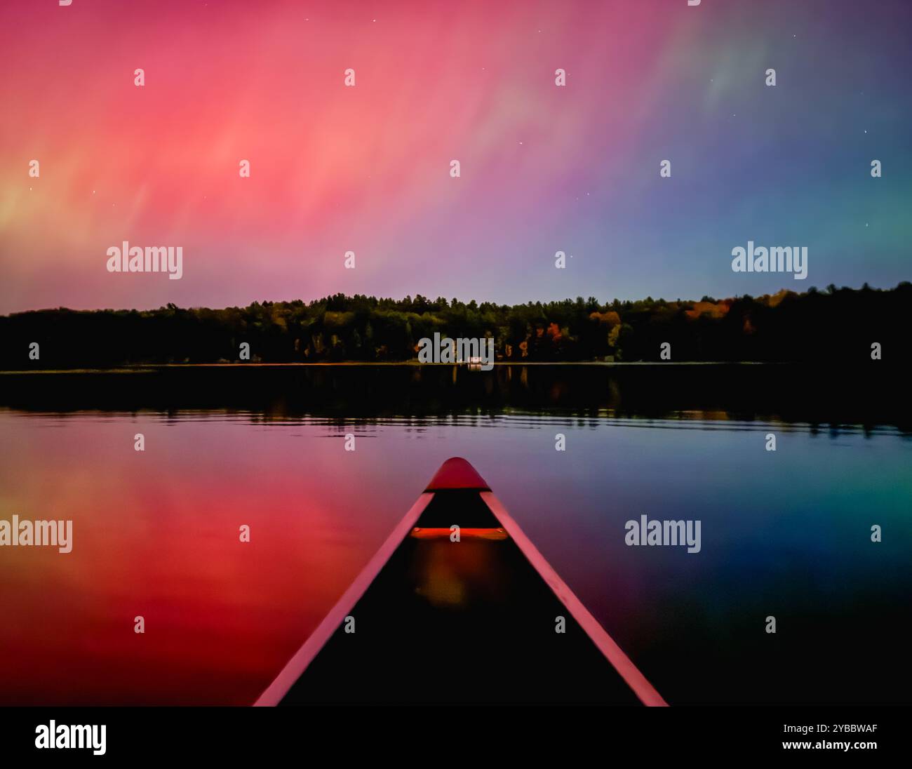 Bow of canoe on lake facing northern lights in night sky Stock Photo ...