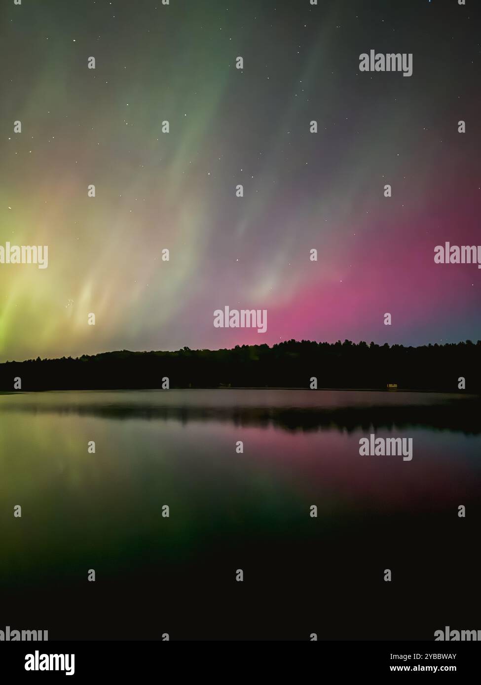 Colorful Aurora Borealis northern lights in sky over lake in Canada ...